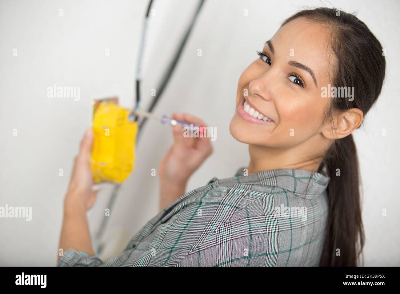 woman testing electrical junction box with a screwdriver Stock Photo ...