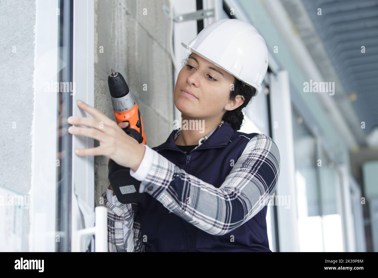 woman drilling with electric power driller Stock Photo - Alamy