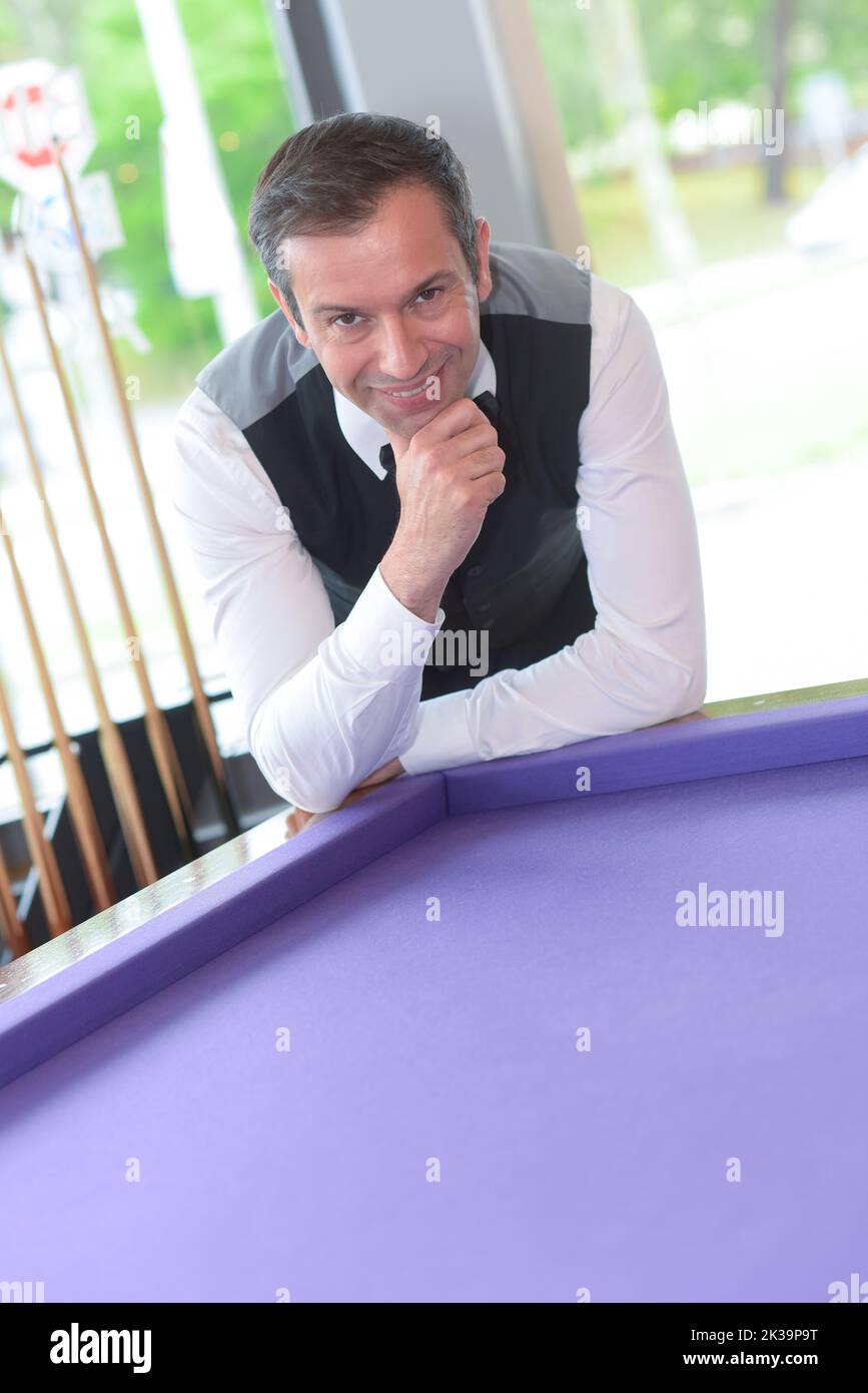 man posing on a billiard table Stock Photo - Alamy