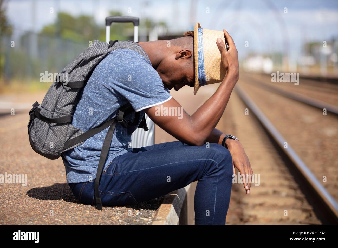 sad young man at the railway station Stock Photo - Alamy