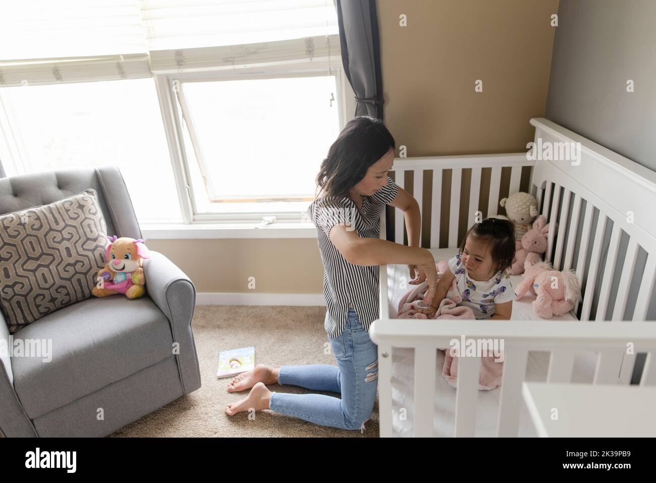 Mother tucking in daughter hi-res stock photography and images - Alamy