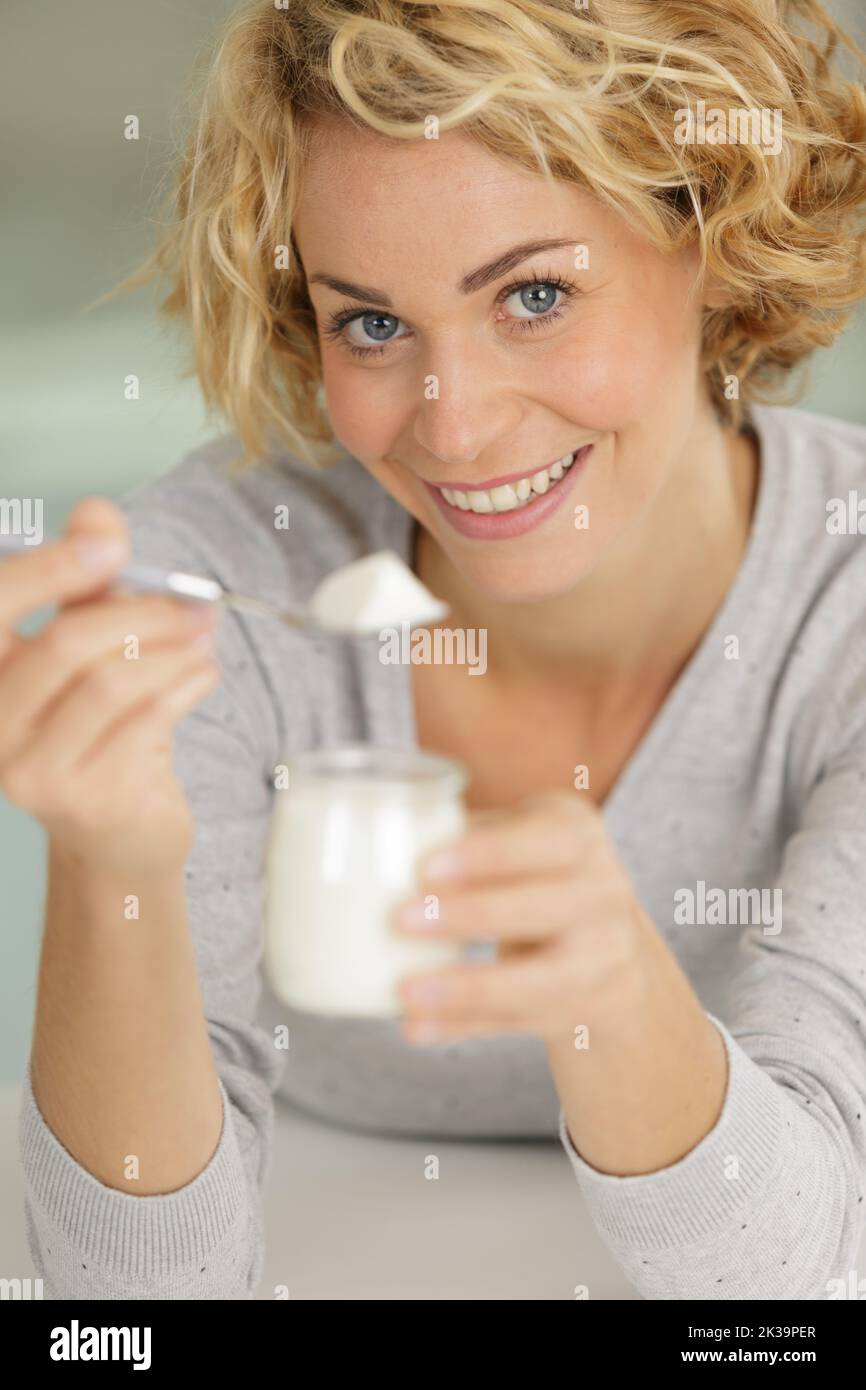 beautiful blonde woman with a bowl of yogurt smiling Stock Photo - Alamy