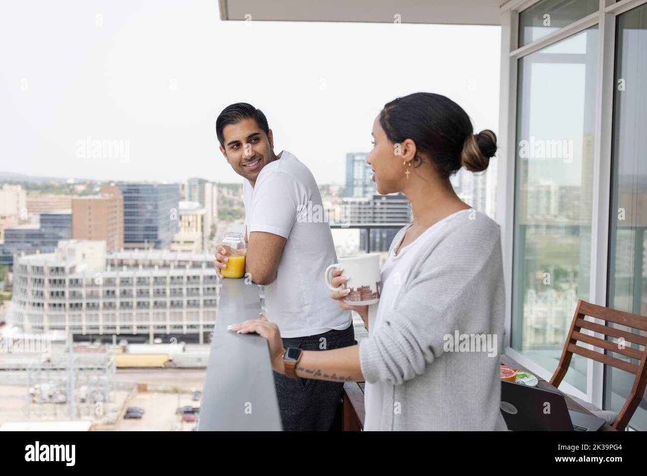 Two people talking on balcony hi-res stock photography and images - Alamy