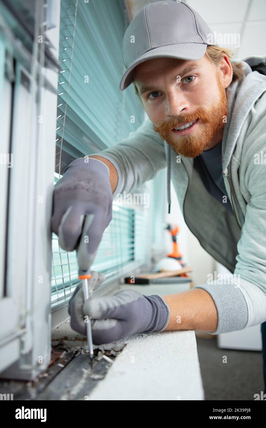 men installing a window in the apartment Stock Photo - Alamy