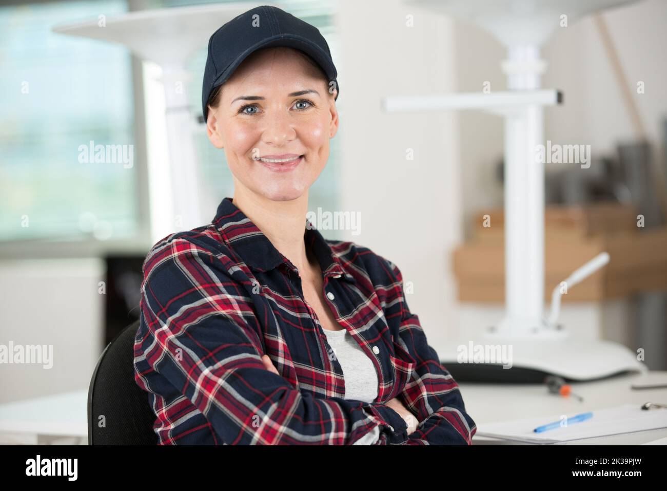 happy female worker after assembling a chair Stock Photo - Alamy