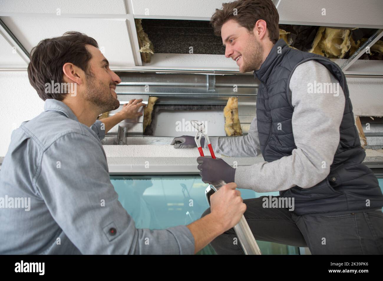 two man having a chat for ceiling house construction Stock Photo - Alamy