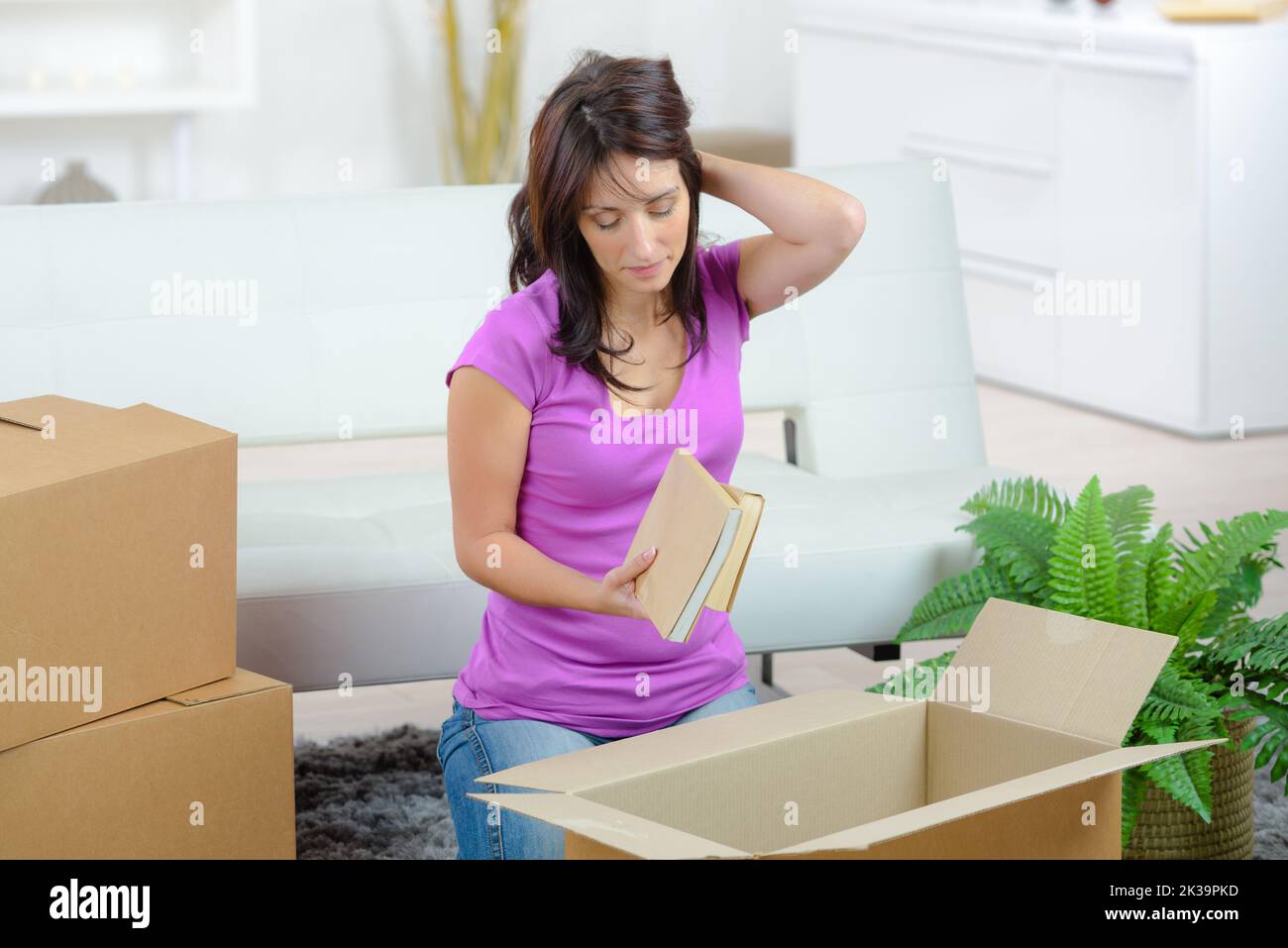 a woman is sorting out exs books Stock Photo - Alamy