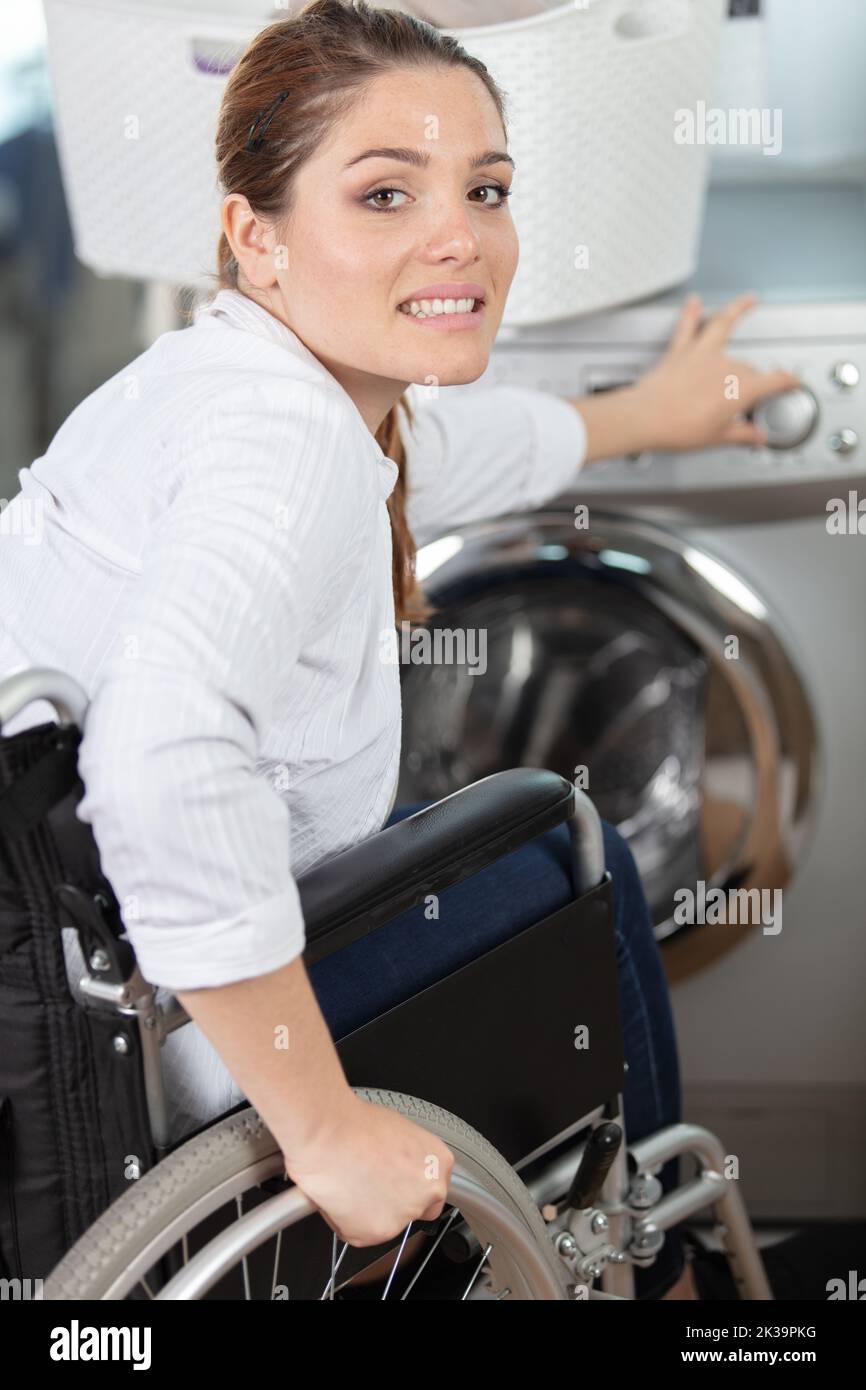 disable woman doing a washing machine Stock Photo - Alamy