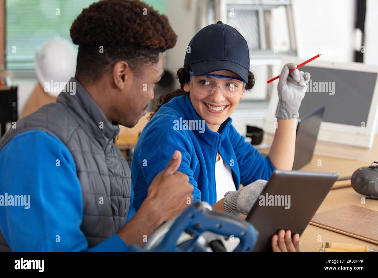 carpenter training female apprentice to use plane Stock Photo - Alamy