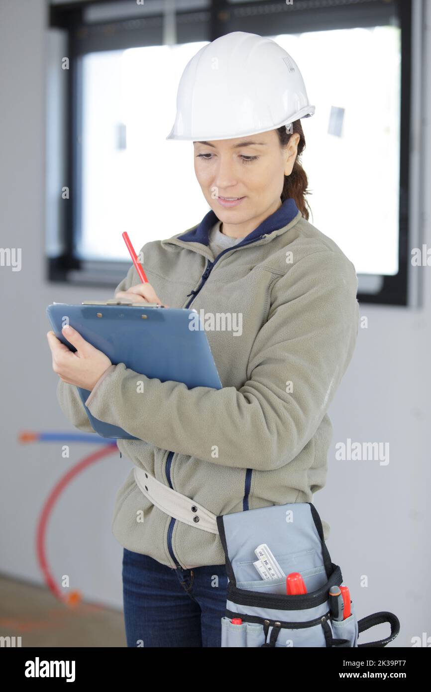 woman builder taking notes at construction site Stock Photo - Alamy