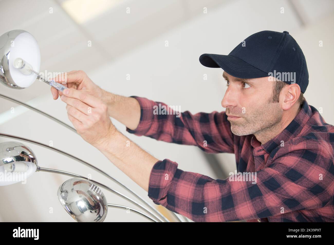 man fitting a new bulb in a lamp Stock Photo - Alamy