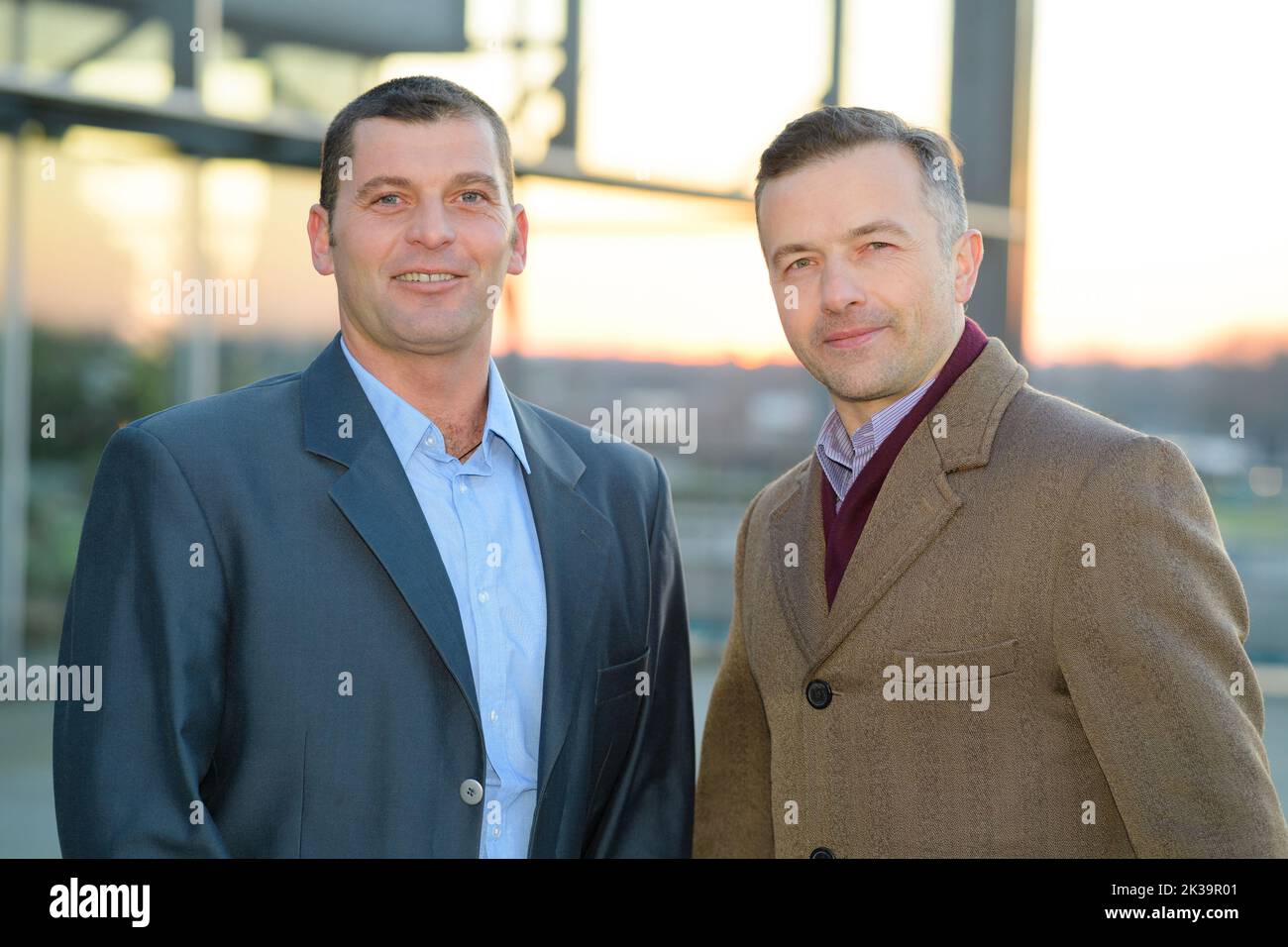 male business partners posing at dusk Stock Photo - Alamy