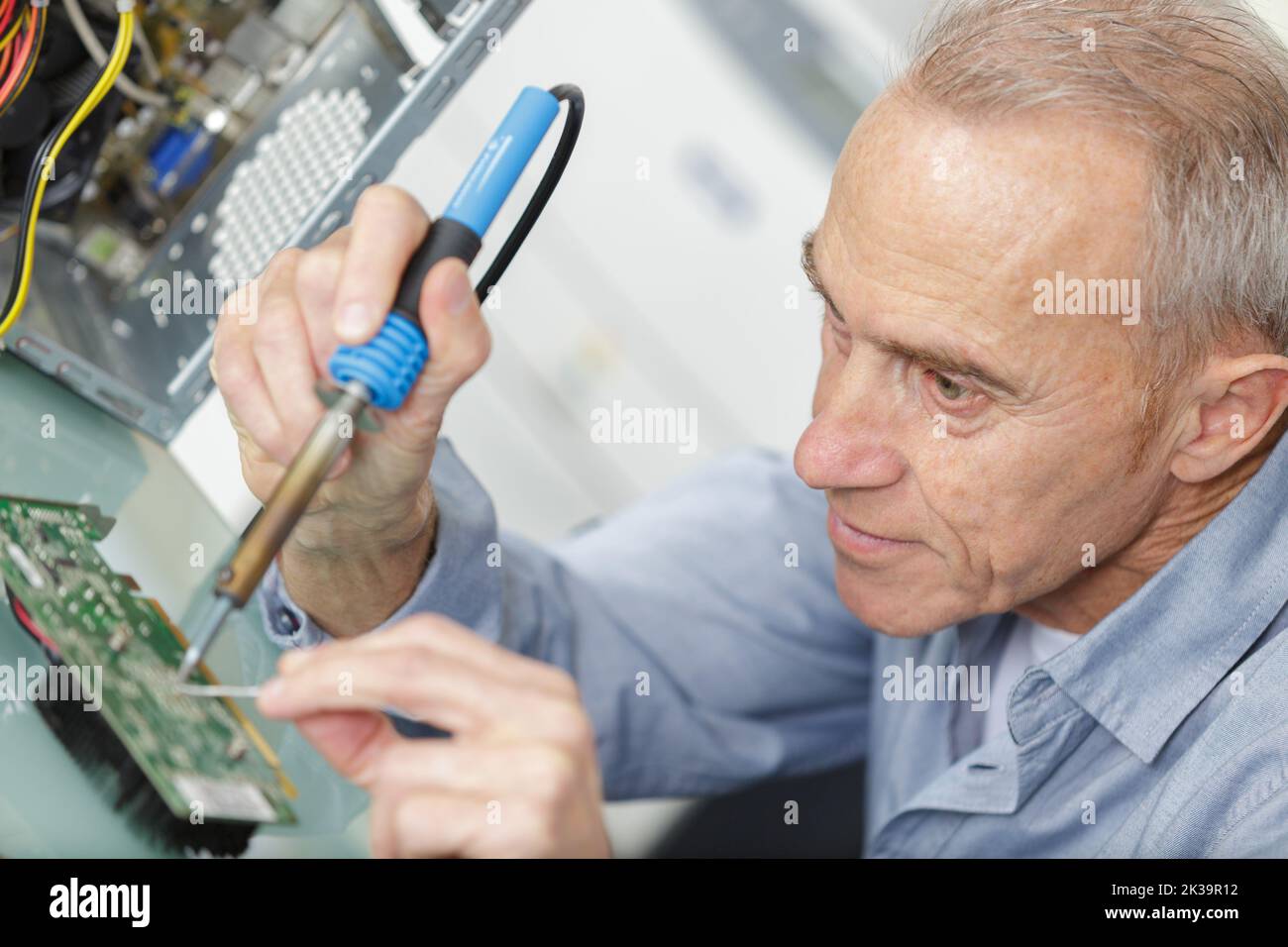 mature man soldering computer equipment Stock Photo - Alamy