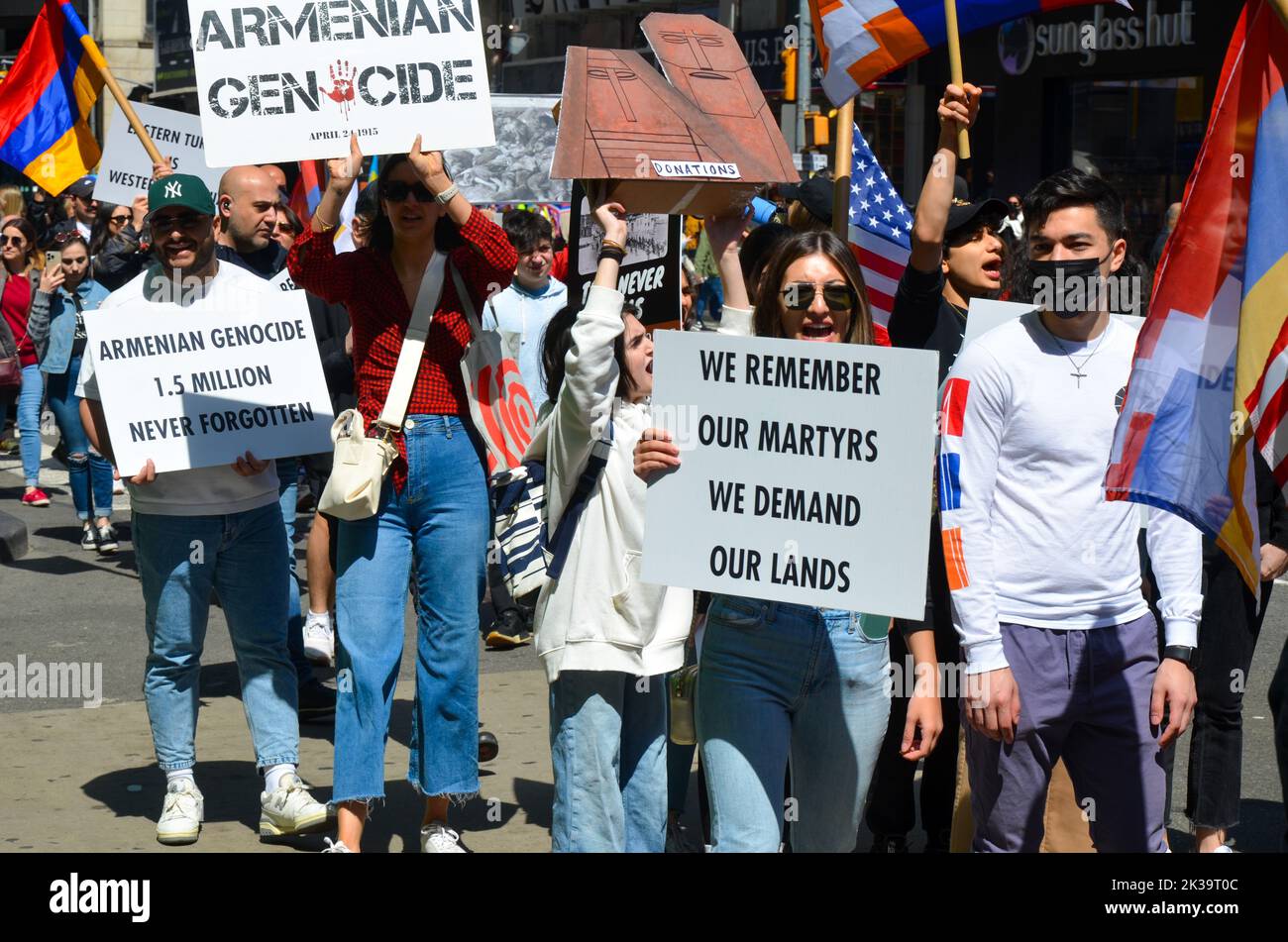 A group of demonstrators holding signs at Times Square during the 107th ...