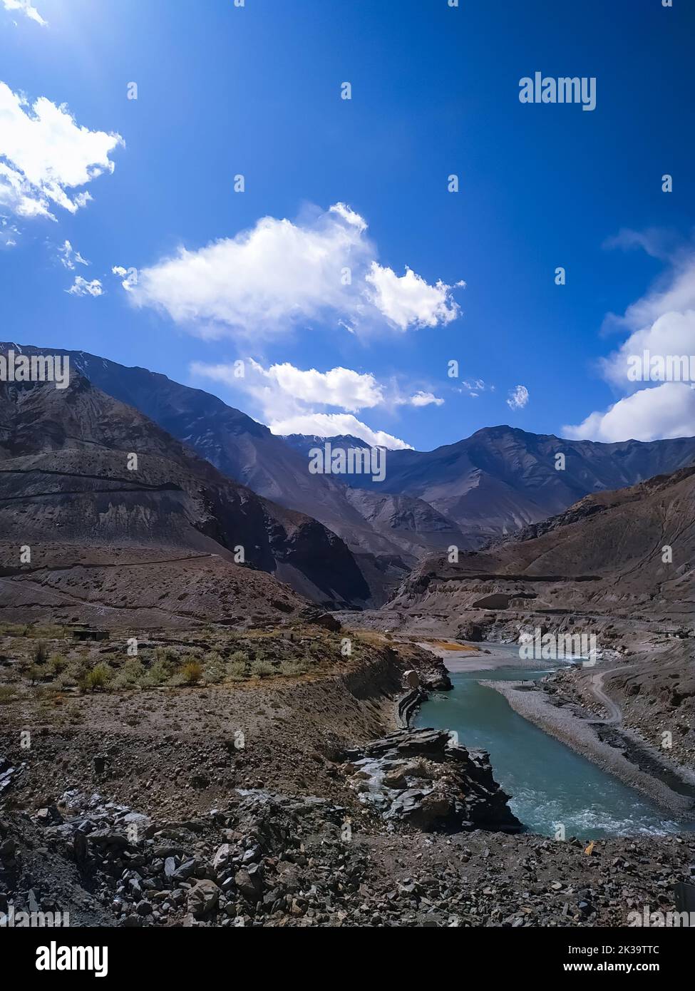 A vertical shot of the Indus River running in a valley in India Stock ...