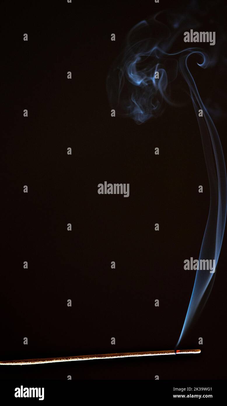 The smoke after aroma stick on dark background Stock Photo - Alamy