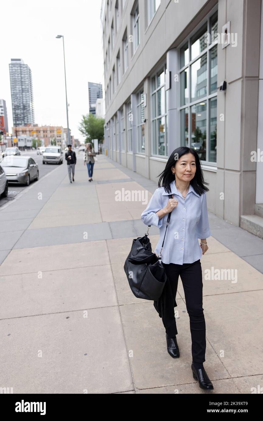 Woman walk back bag hi-res stock photography and images - Alamy