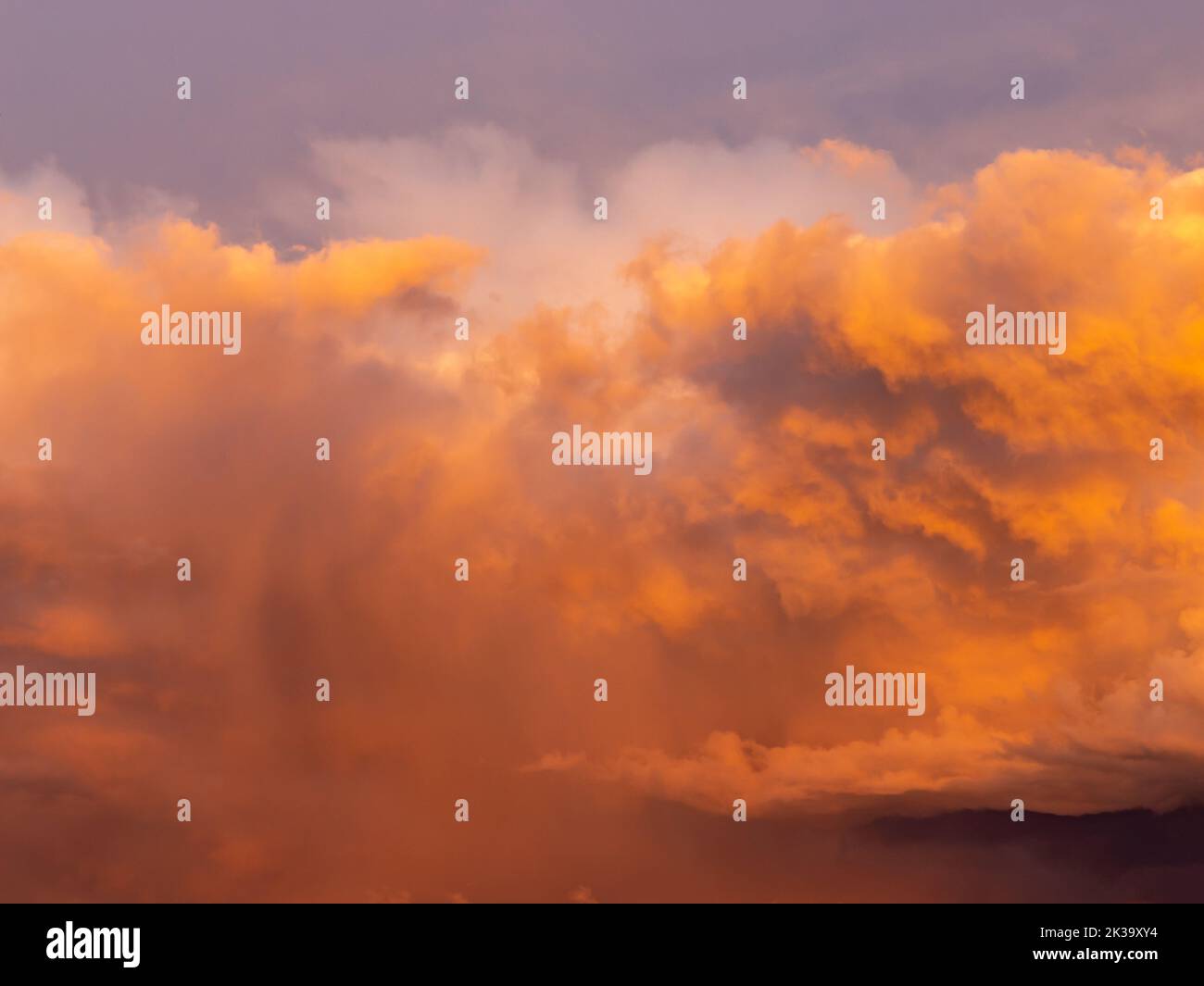 Colorful orange thunderstorm clouds at sunset time. Close-up of a ...