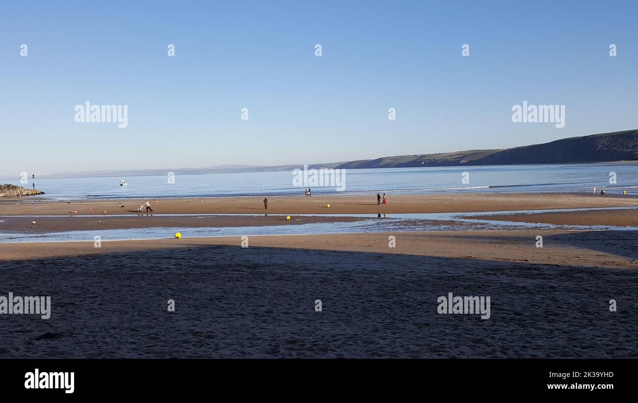 A beautiful view of the New Quay Harbor in the United Kingdom with a ...