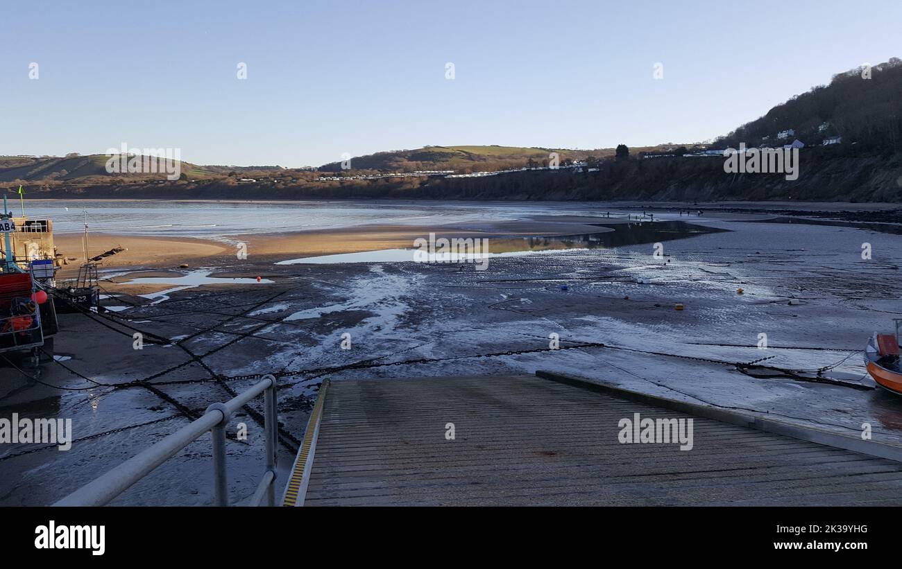 A beautiful view of the New Quay Harbor in the United Kingdom with a ...
