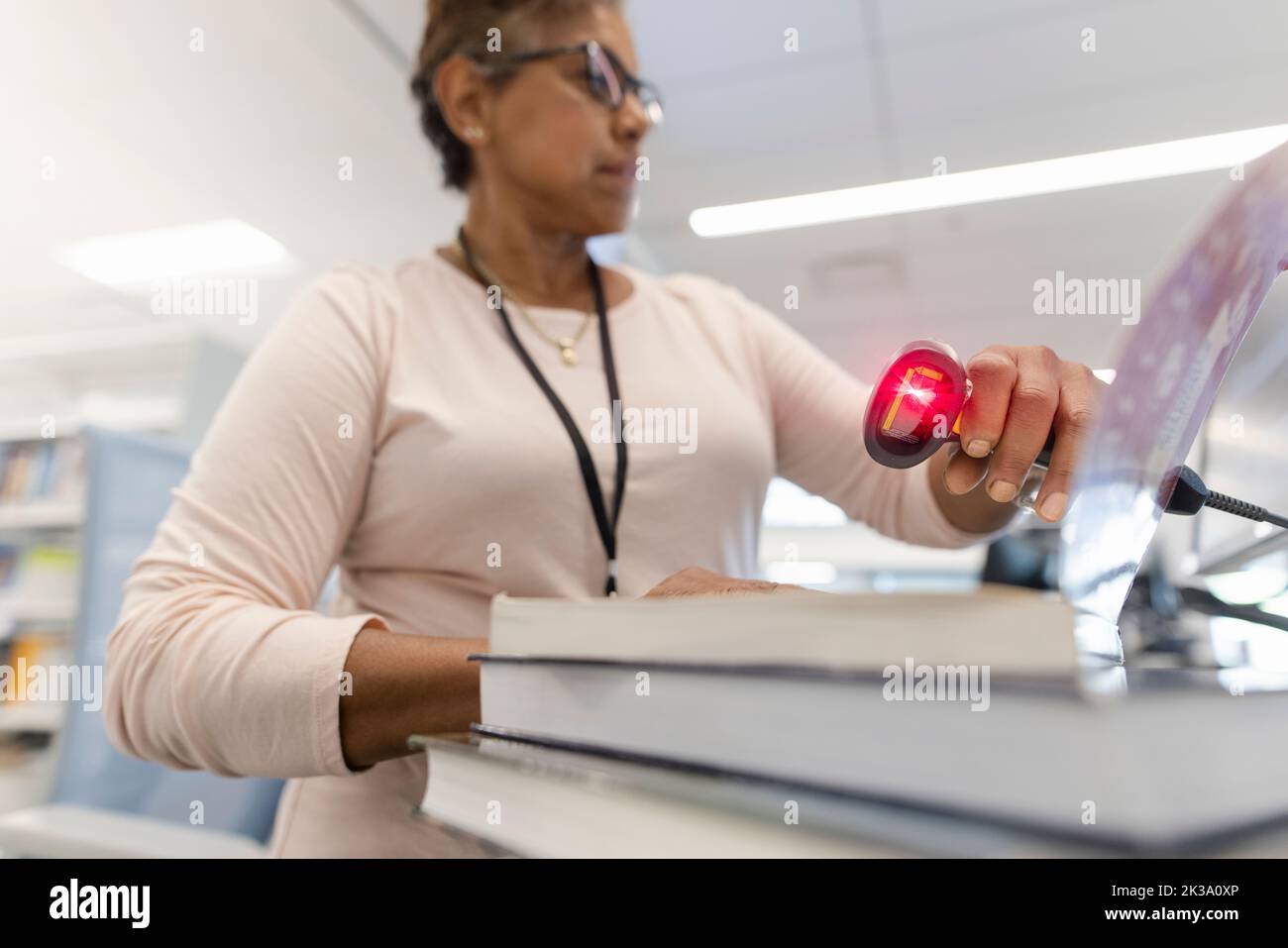 Checking out library book hi-res stock photography and images - Alamy