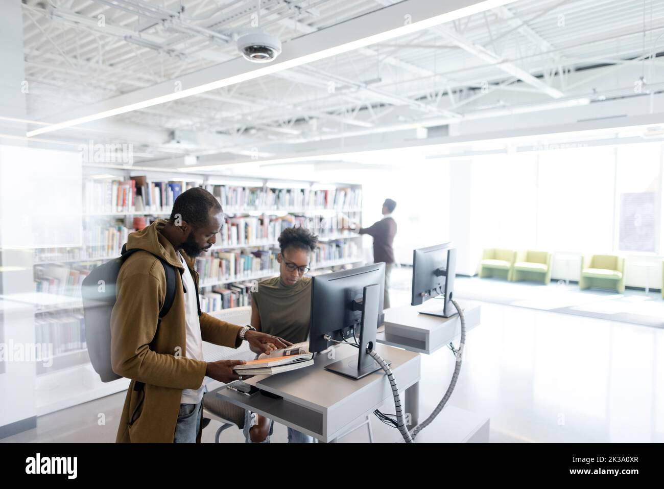 Two students talking at desk hi-res stock photography and images - Alamy