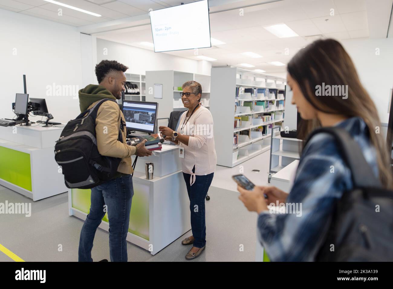 Checking out books library hi-res stock photography and images - Alamy