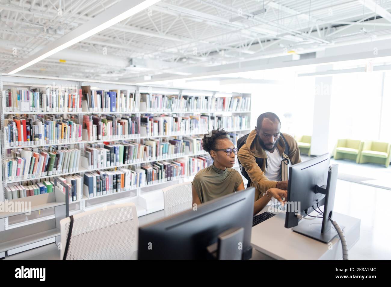 Two students talking at desk hi-res stock photography and images - Alamy