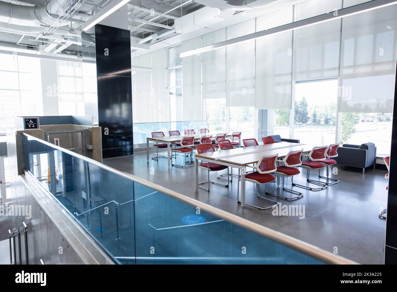Tables and chairs in empty college library Stock Photo - Alamy