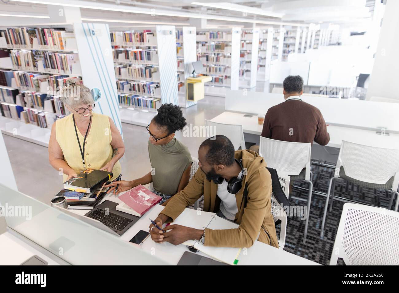 Four people in library standing hi-res stock photography and images - Alamy