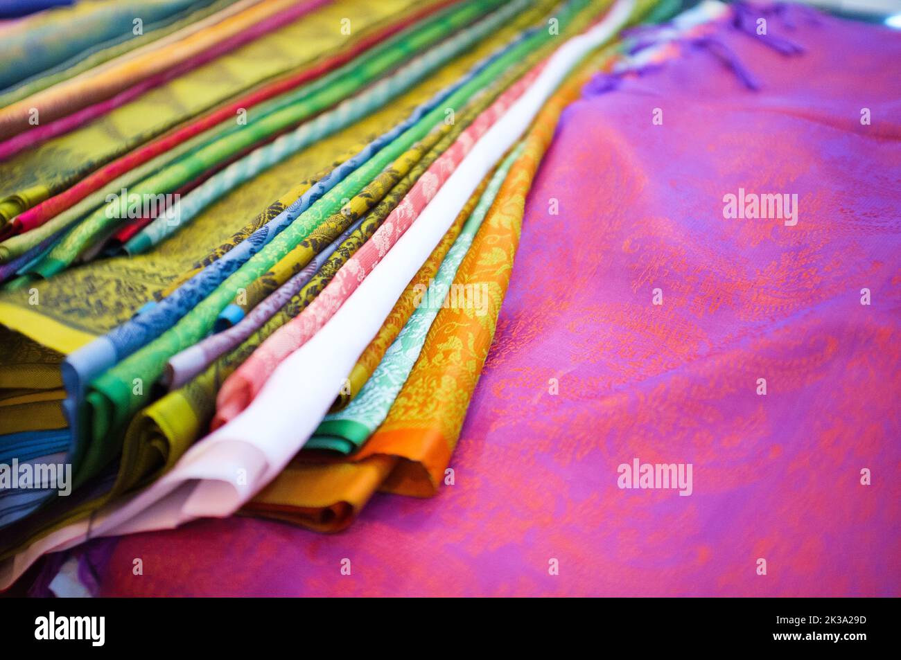 A closeup of various types and colors of silk fabric in Mysore, India ...