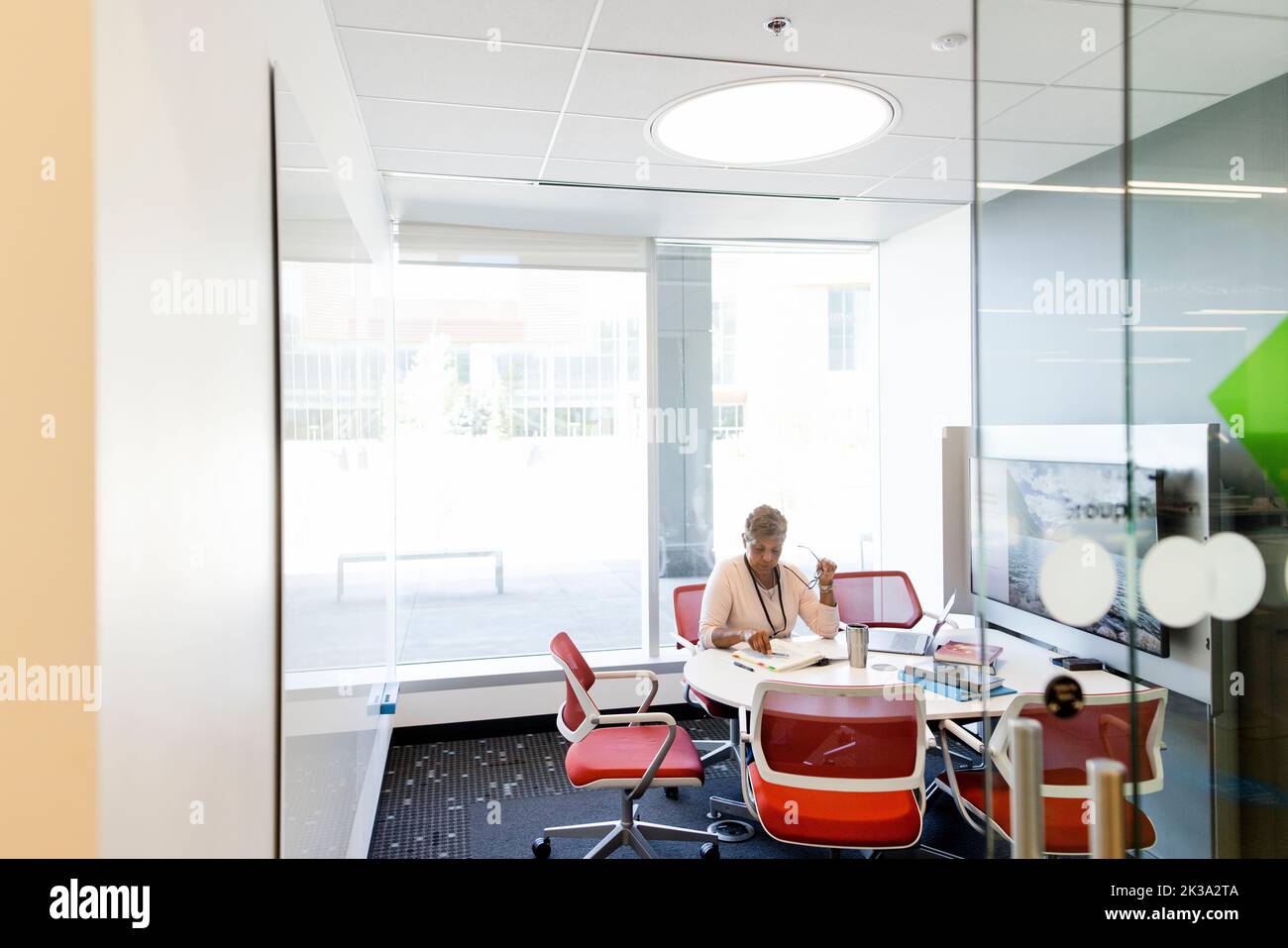 Female professor reading in library study room Stock Photo - Alamy