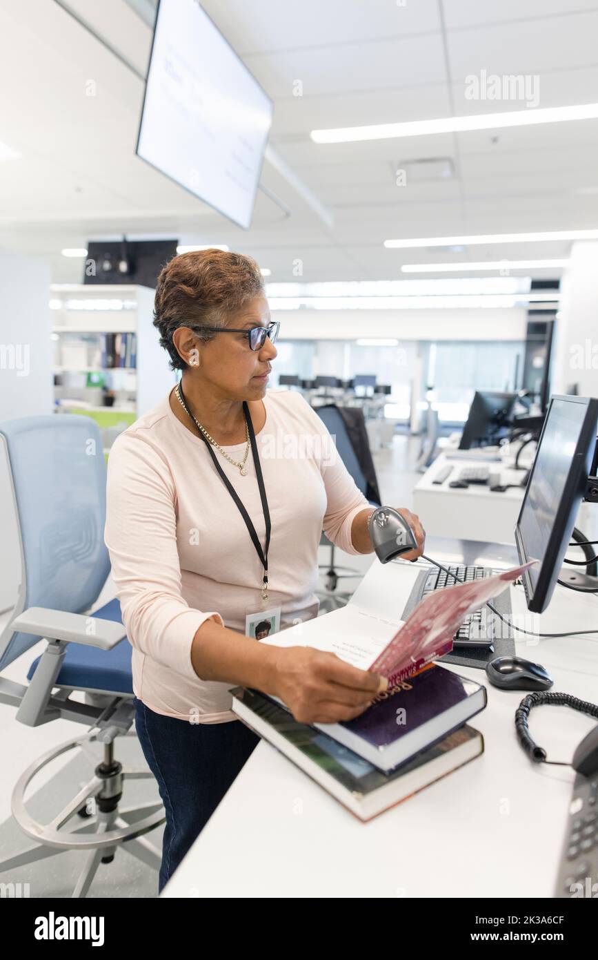 Checking out library book hi-res stock photography and images - Alamy