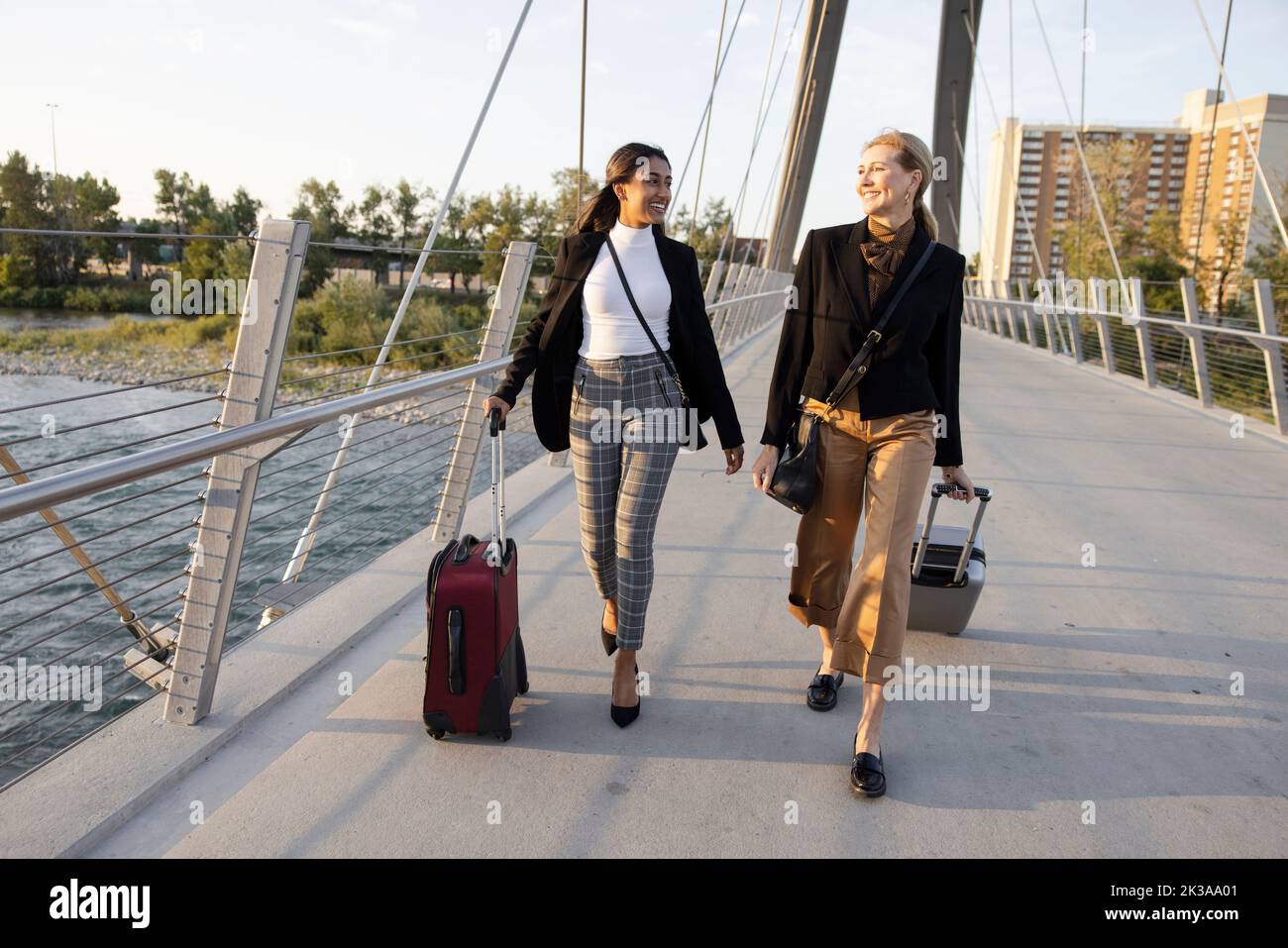 Multiethnic business people walking over city bridge Stock Photo - Alamy