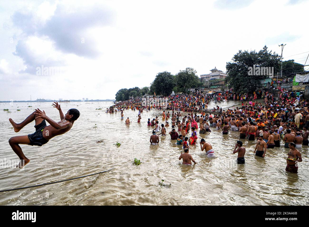 A child jumps into the River Ganges during the Mahalaya celebration ...
