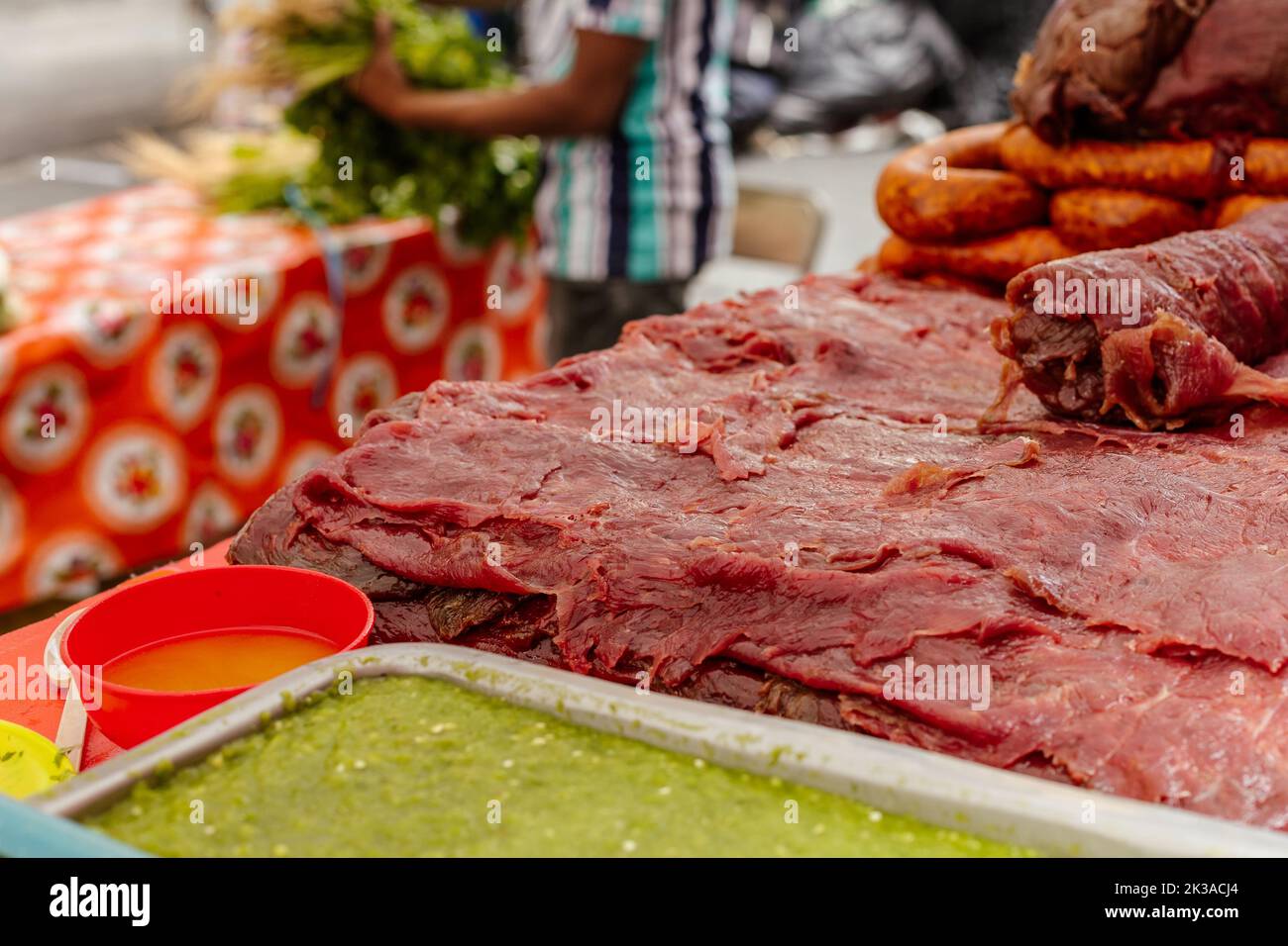 preparation of meat for roasting for sale in a market Stock Photo - Alamy