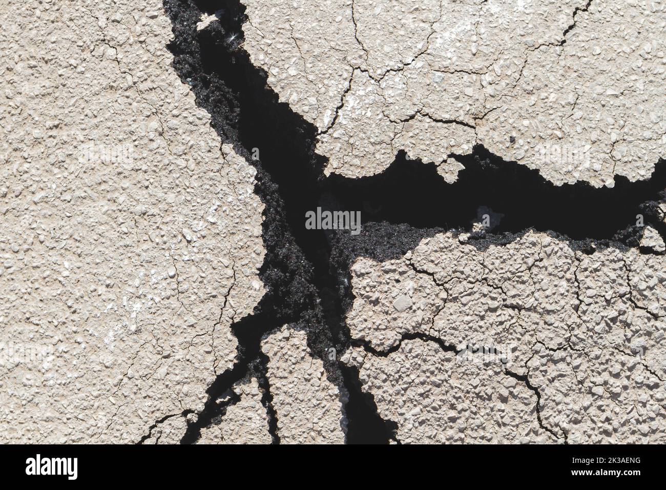 Ruins on road. Cracked asphalt. Deep crack in road. Faults in ground ...