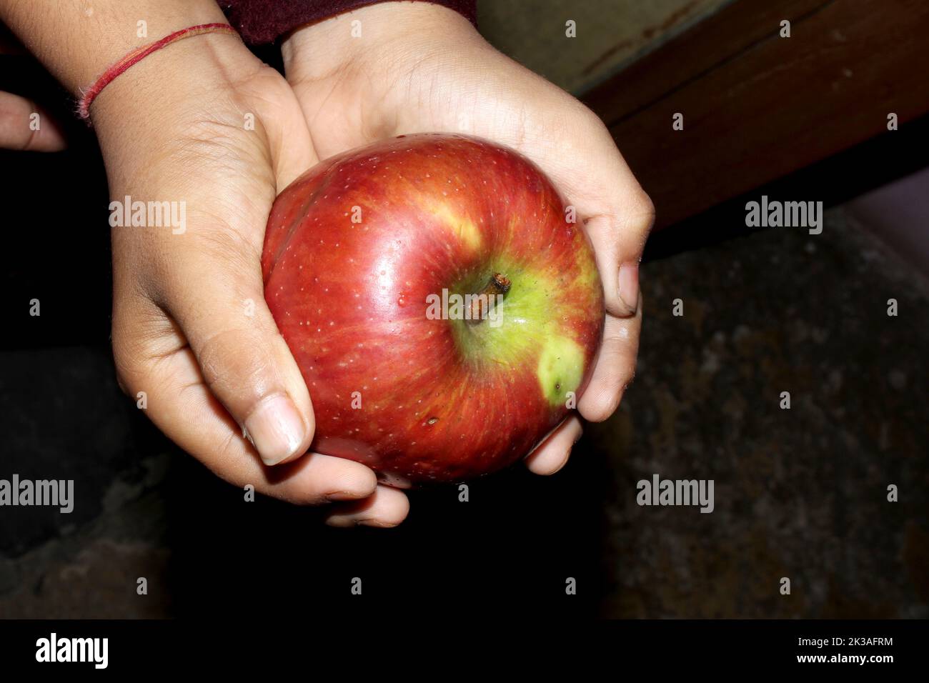 fresh red sweet apple in a both hand Stock Photo - Alamy