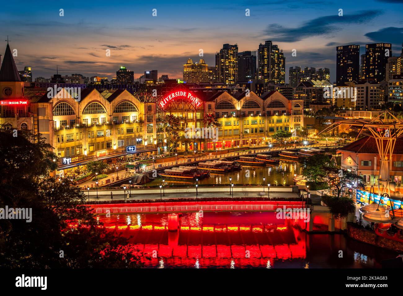 Scenic nightscape of Riverside Point, Clarke Quay with Bumboat cruising in Singapore River ...