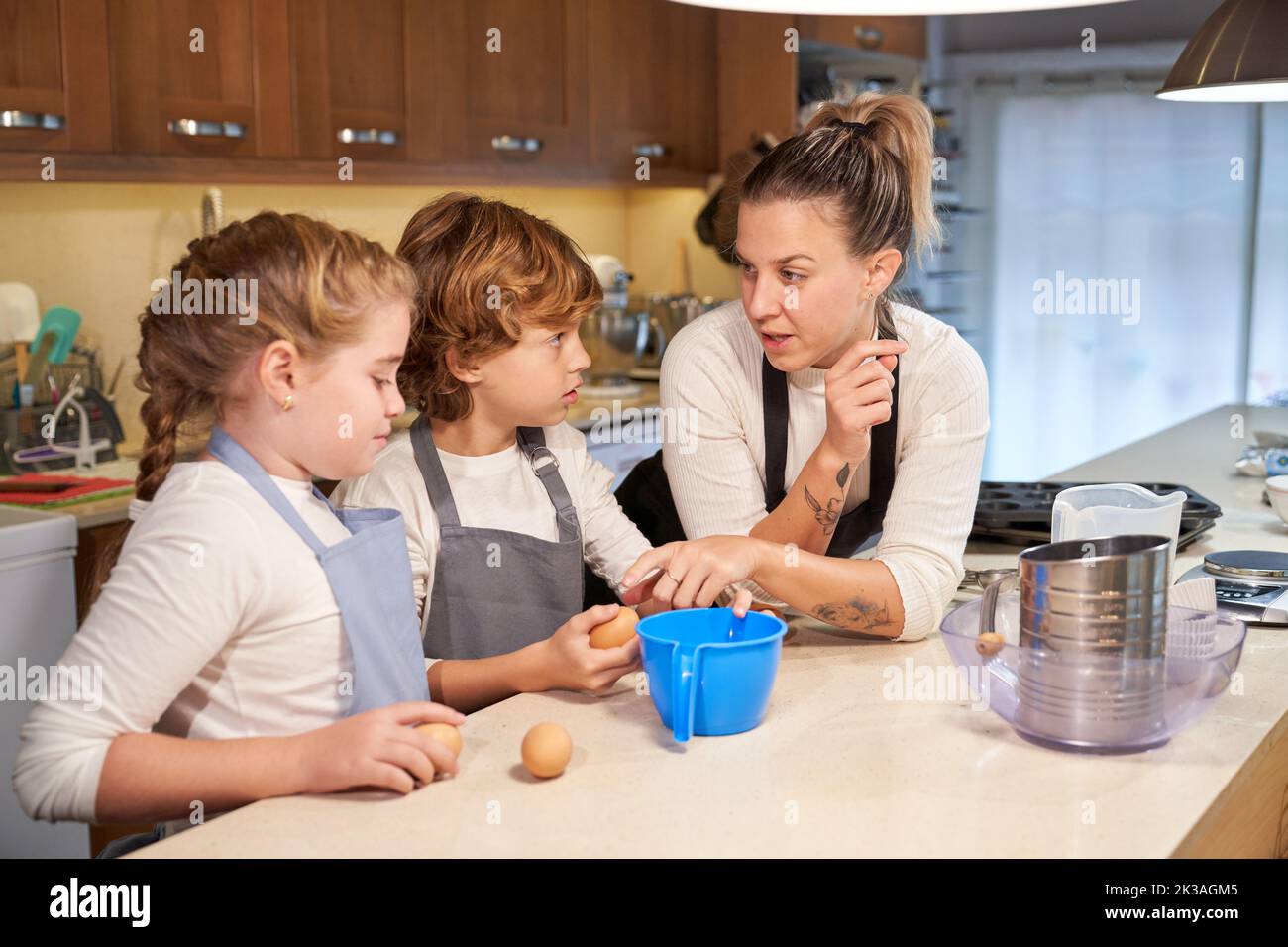 Woman teaching child prepare dough hi-res stock photography and images ...