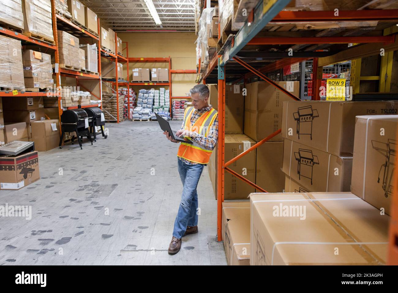 Leaning on shelves in distribution warehouse hi-res stock photography ...