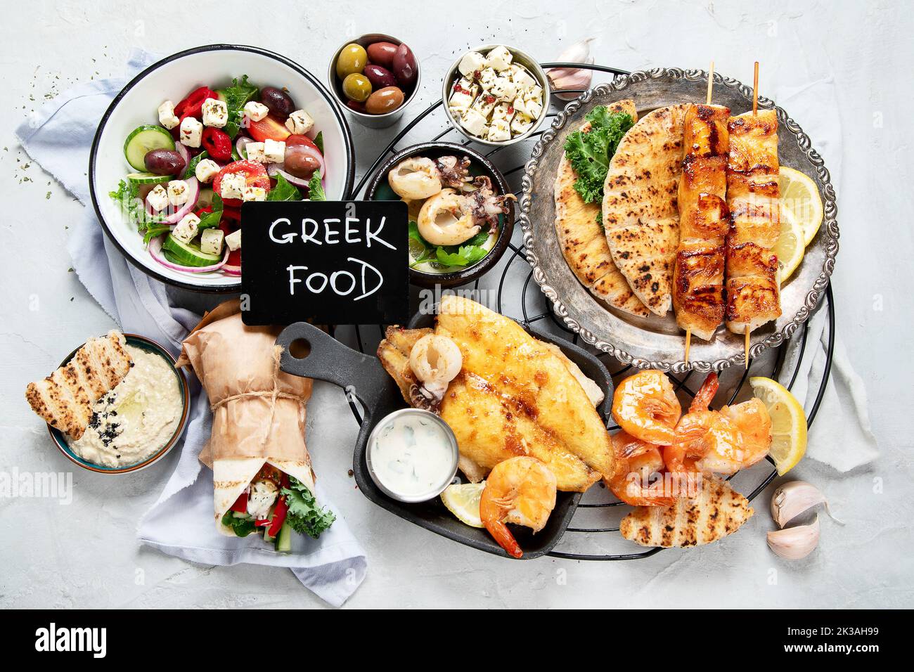 Greek food background. Meze, gyros, souvlaki, fish, pita, greek salad ...