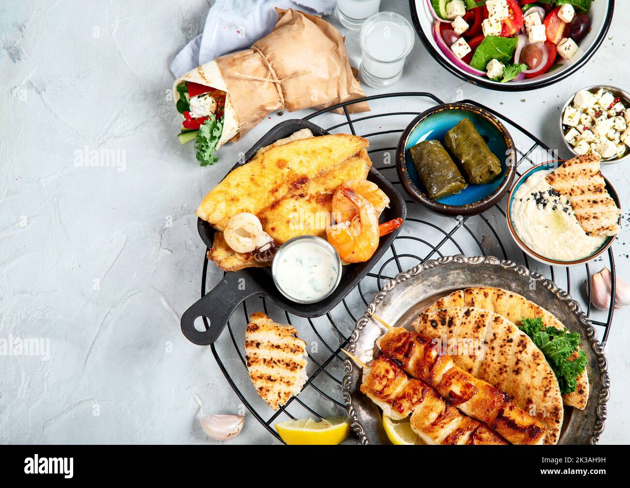 Greek food background. Meze, gyros, souvlaki, fish, pita, greek salad ...