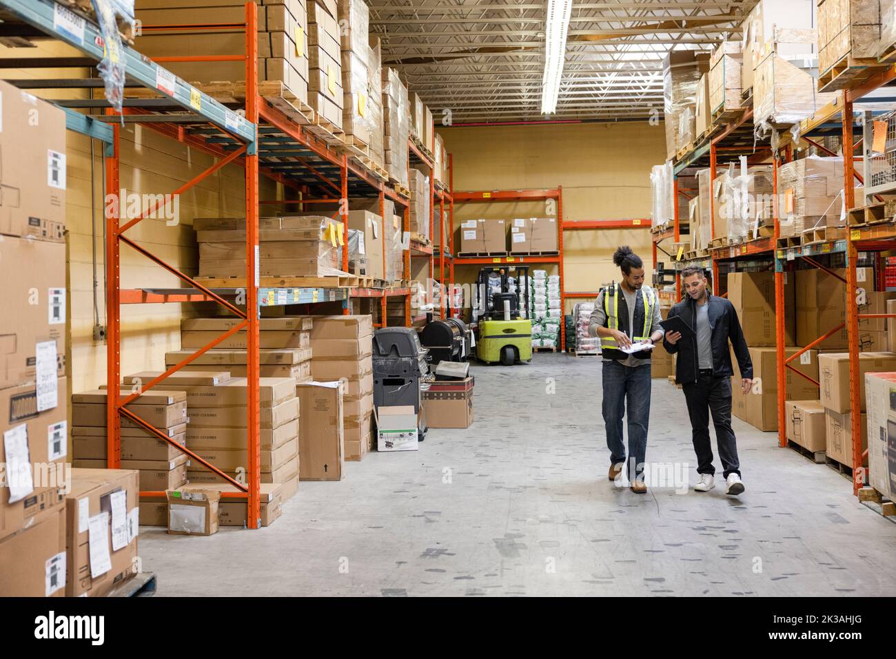 colleagues discussing work in distribution warehouse Stock Photo - Alamy