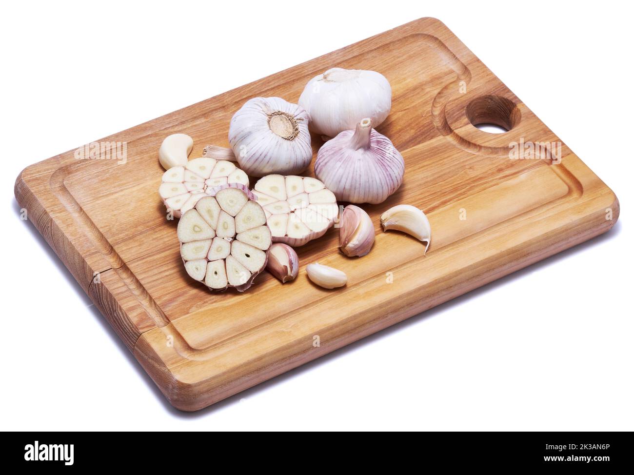 Sliced garlic on wooden Cut Out Stock Images & Pictures - Alamy