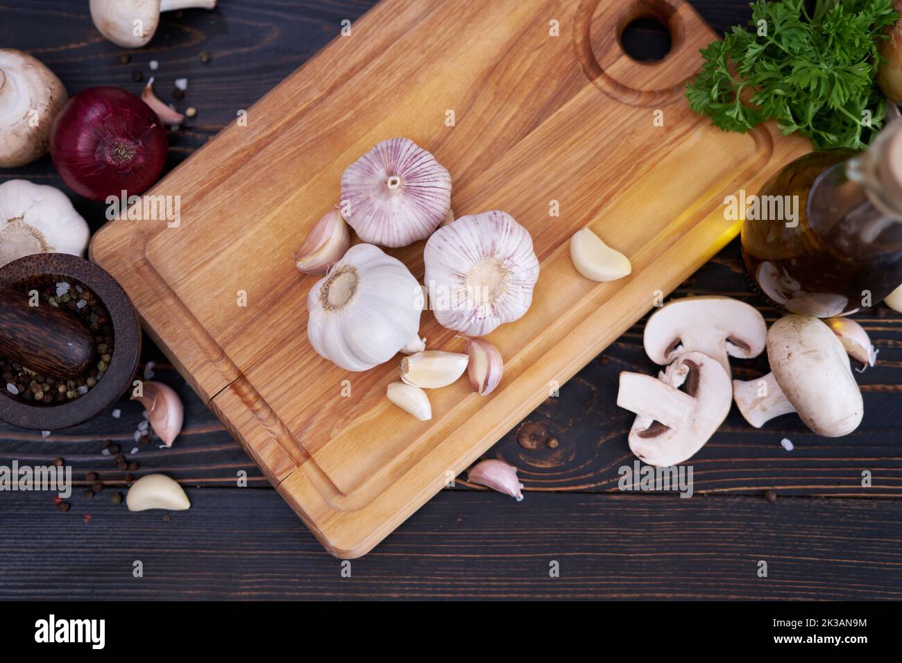 Garlic on wooden chopping board on wooden background or table Stock ...
