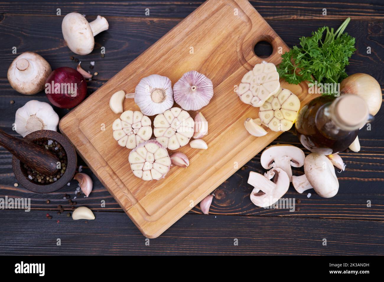 Garlic on wooden chopping board on wooden background or table Stock ...