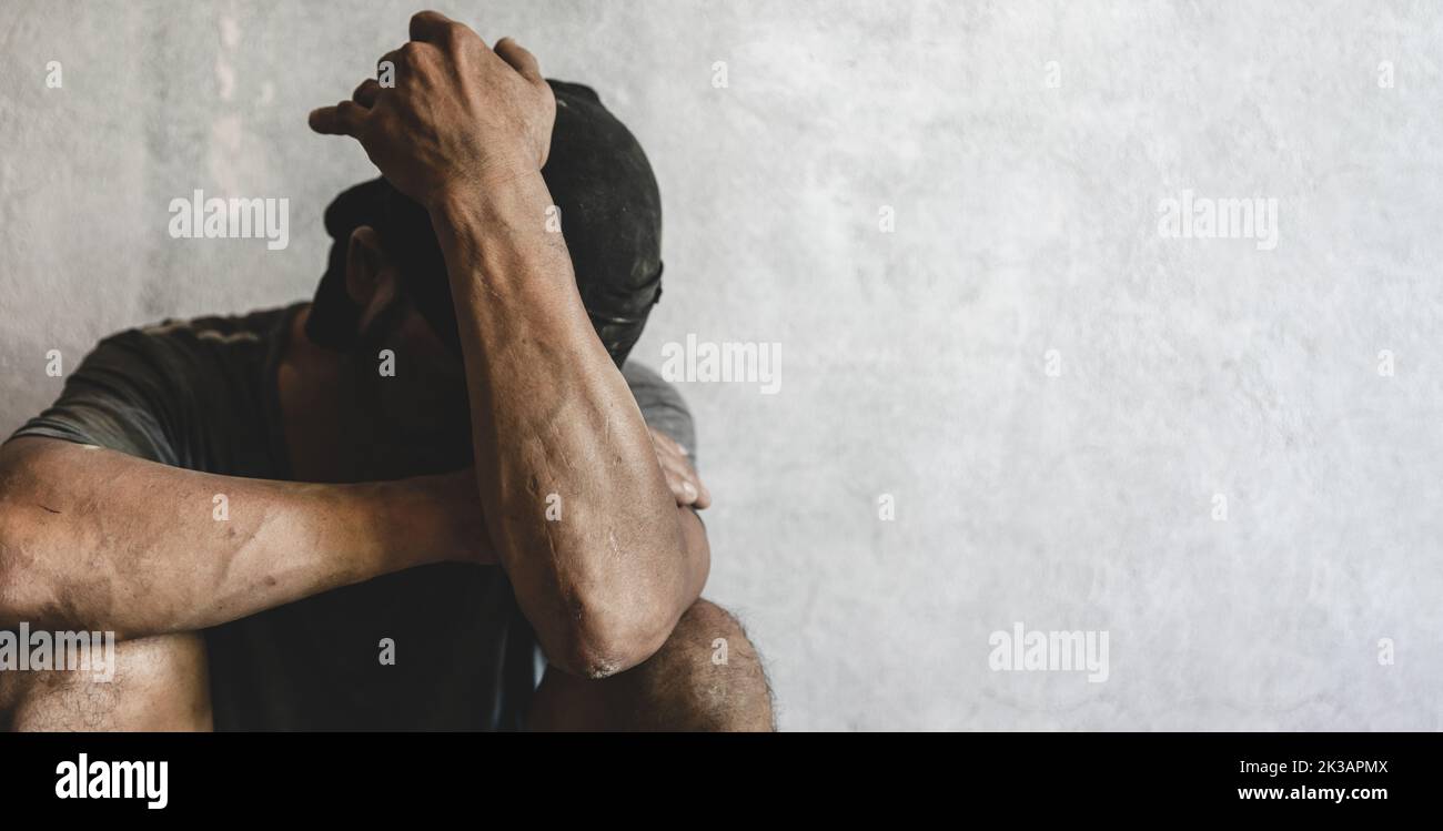 Homeless man drug and alcohol addict sitting alone and depressed ...