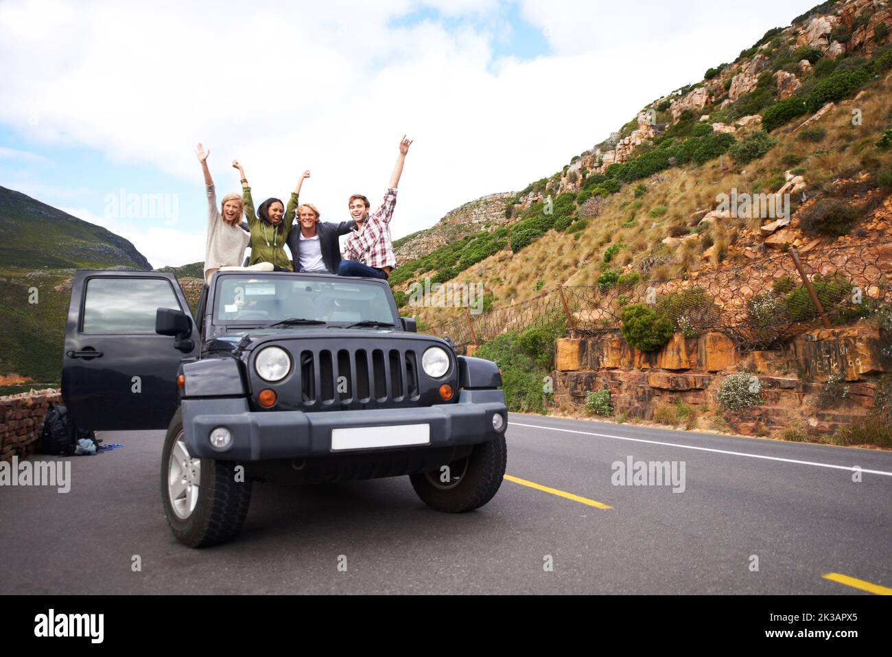Freedom for all. a group of friends raising their arms as they enjoy ...