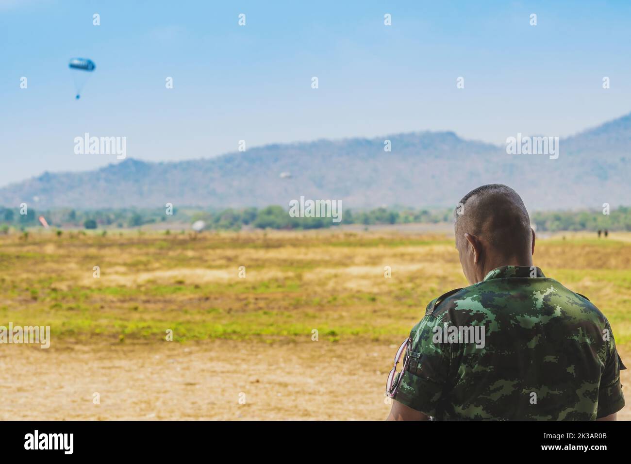 Back view of Asian army soldier stands to explore the landscape in ...